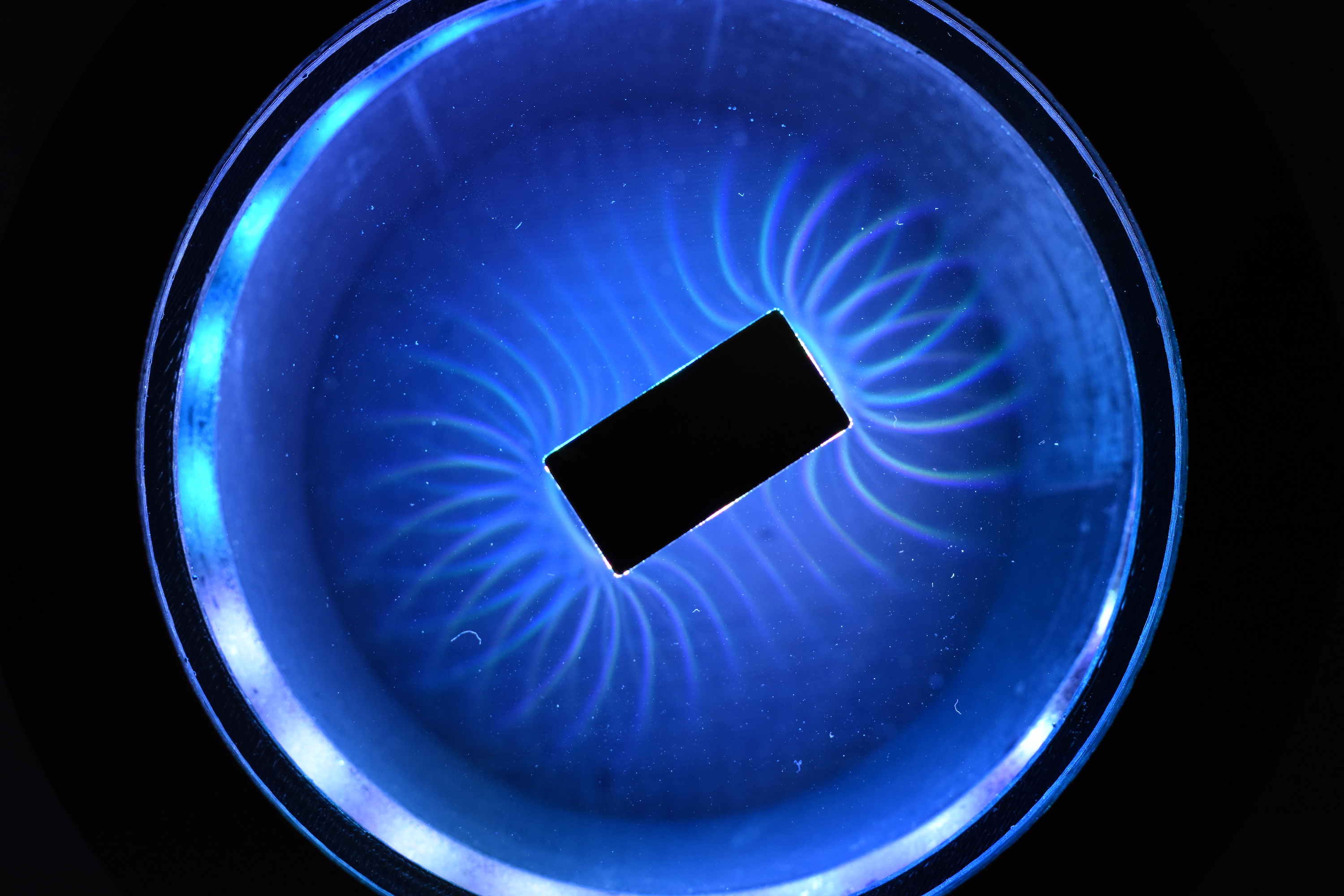 Viewed in a dark room with the bottom cover removed against a black ...